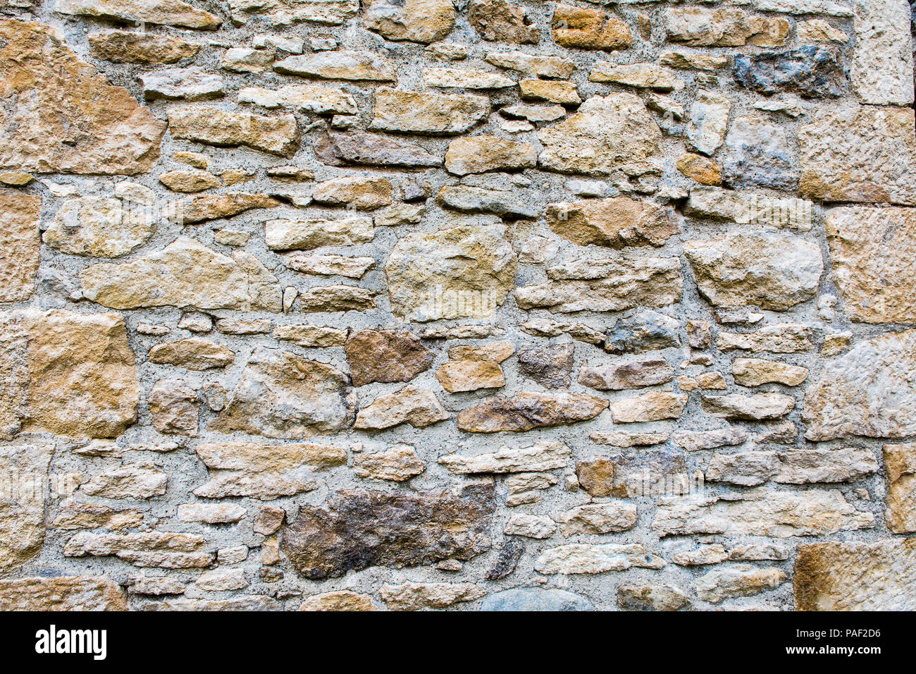 Fragment of a fortified wall made of stones of different types and ...