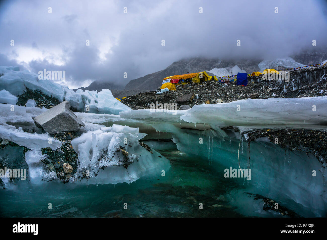 Beautiful water stream flowing under Everest Base Camp, ice over water ...