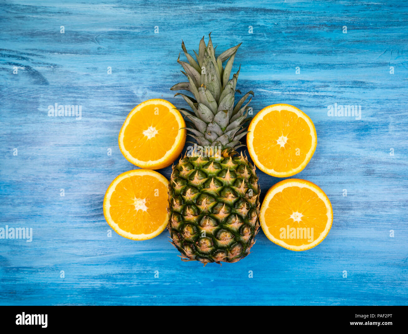 Pineapple with orange halves Stock Photo - Alamy