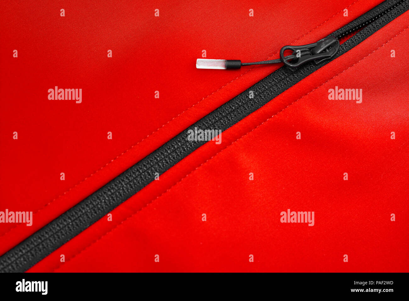 Closed zipper of a red jacket Stock Photo - Alamy