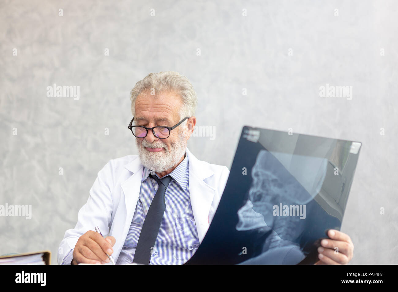 Senior medical doctor or chief doctor or Surgeon are checking skull of ...
