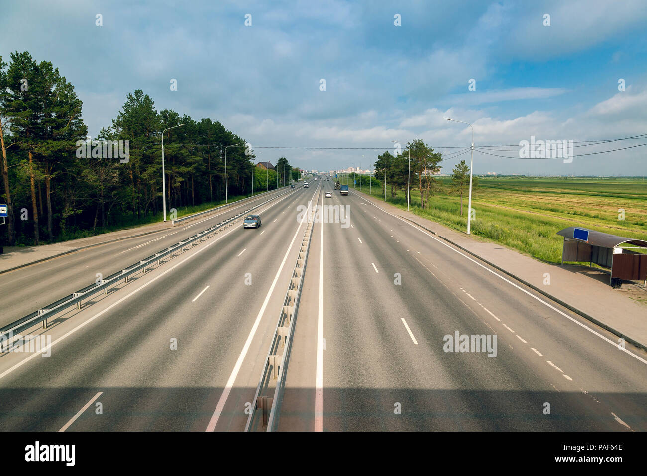 Two-lane freeway with one-way traffic in front of the city Stock Photo ...