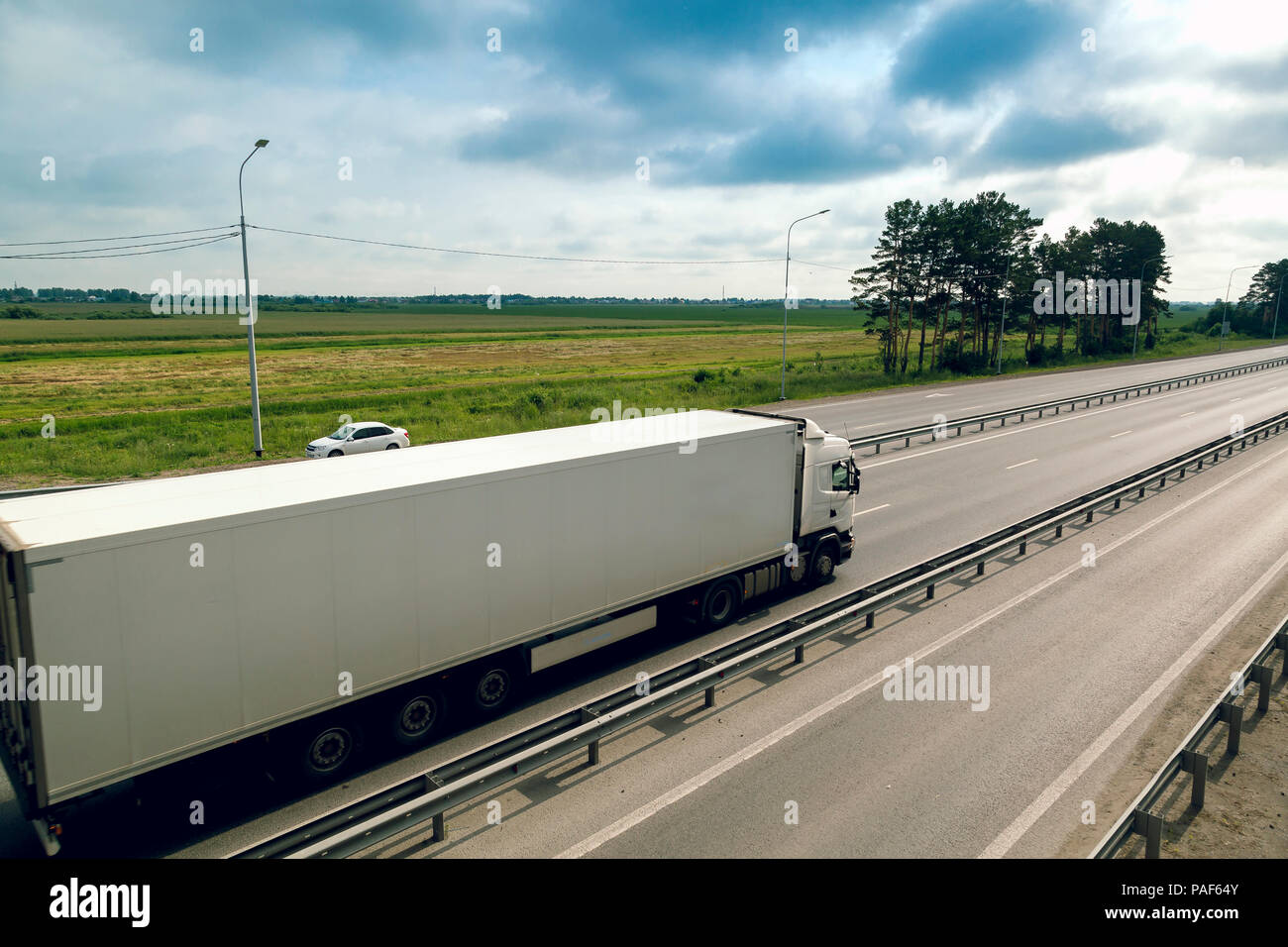 Two-lane freeway with one-way traffic in front of the city Stock Photo ...