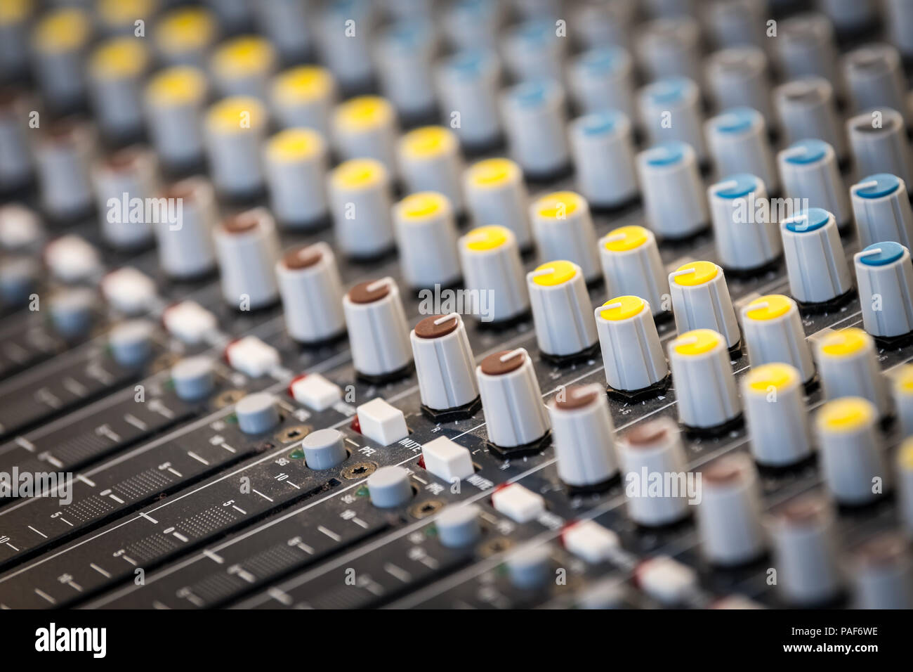 Detail of a sound mixing panel with various knobs Stock Photo - Alamy