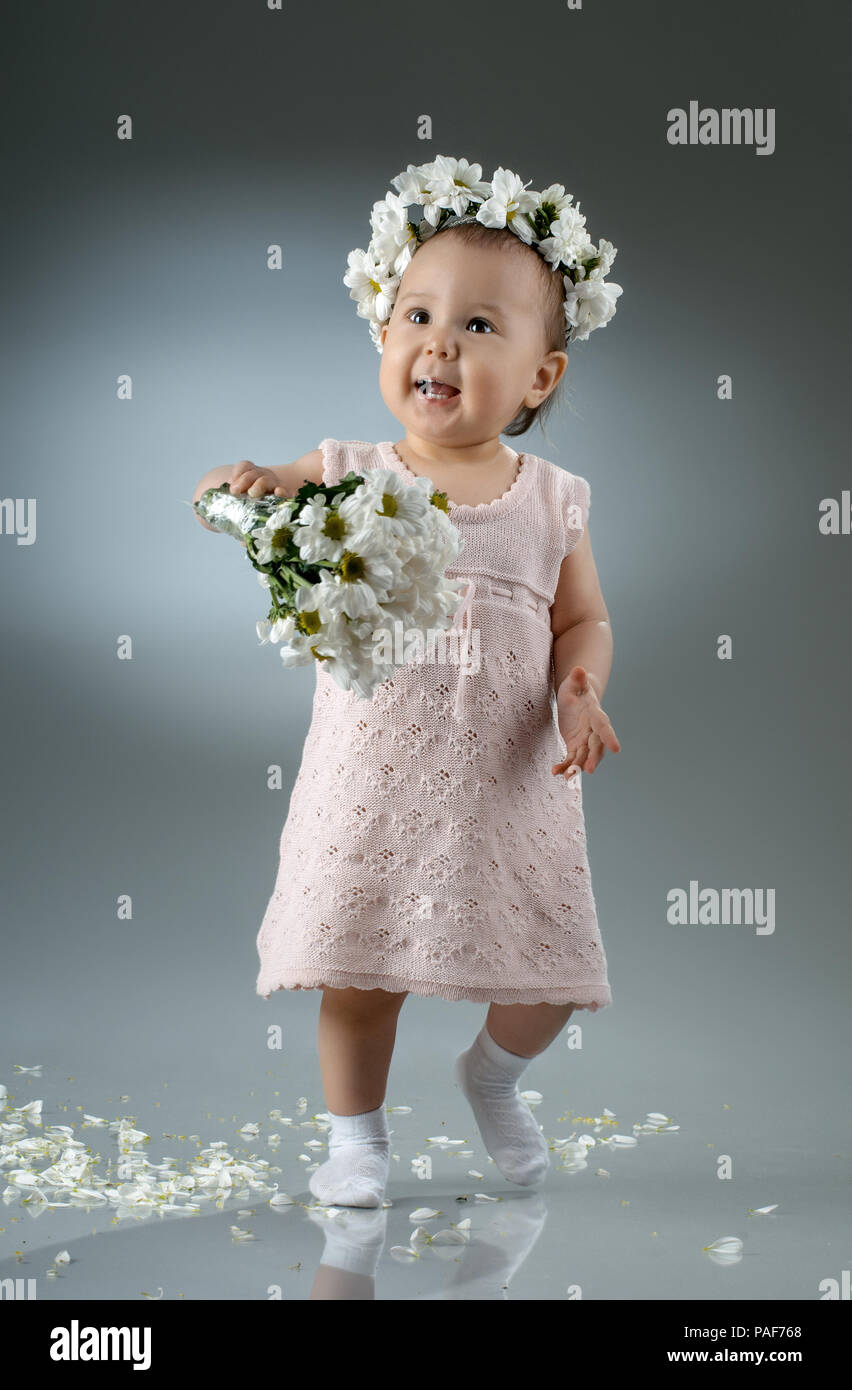 beautiful little baby girl, with bouquet and diadem of flowers Stock ...