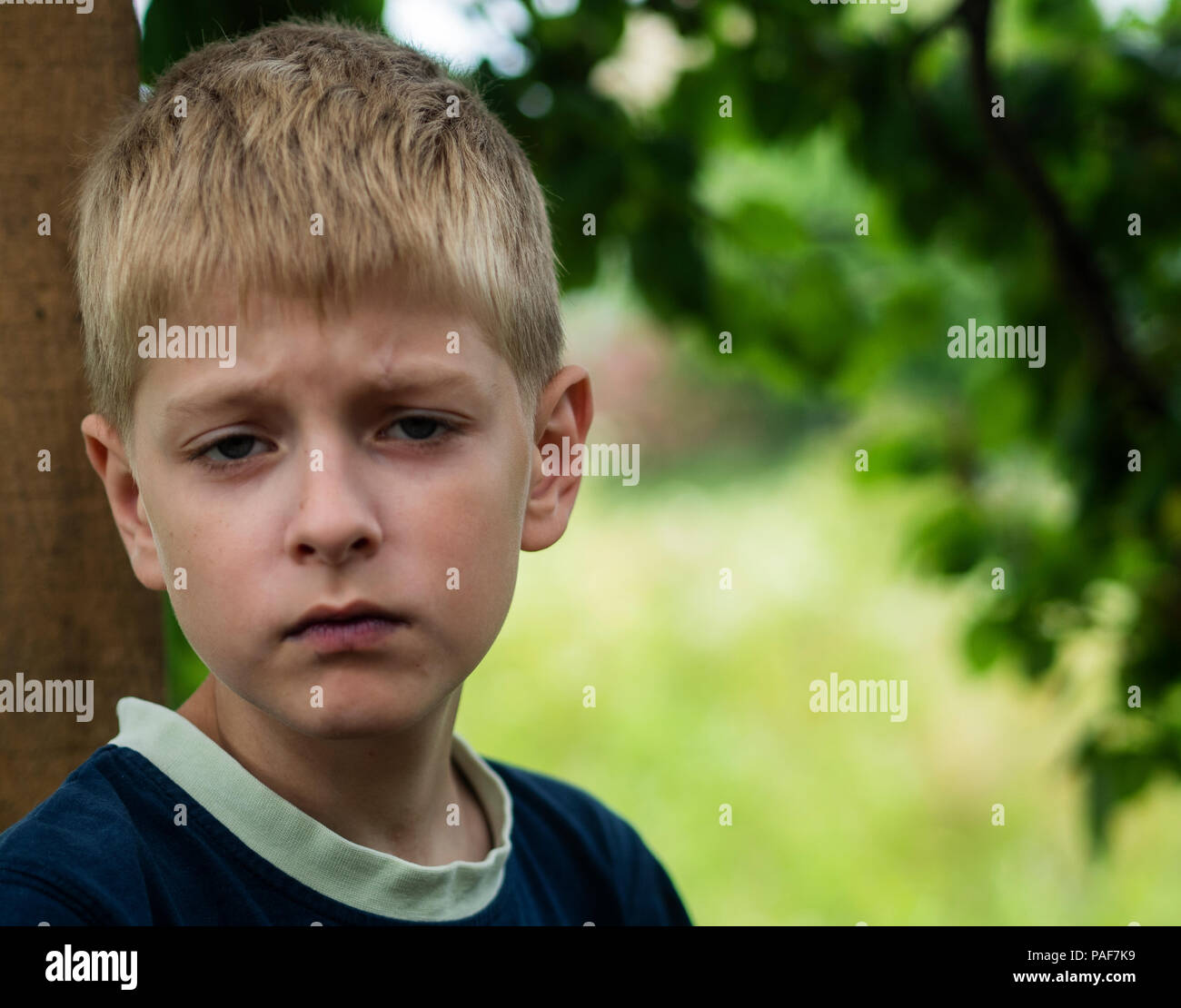 Cute sad handsome boy's outdoor portrait Stock Photo - Alamy