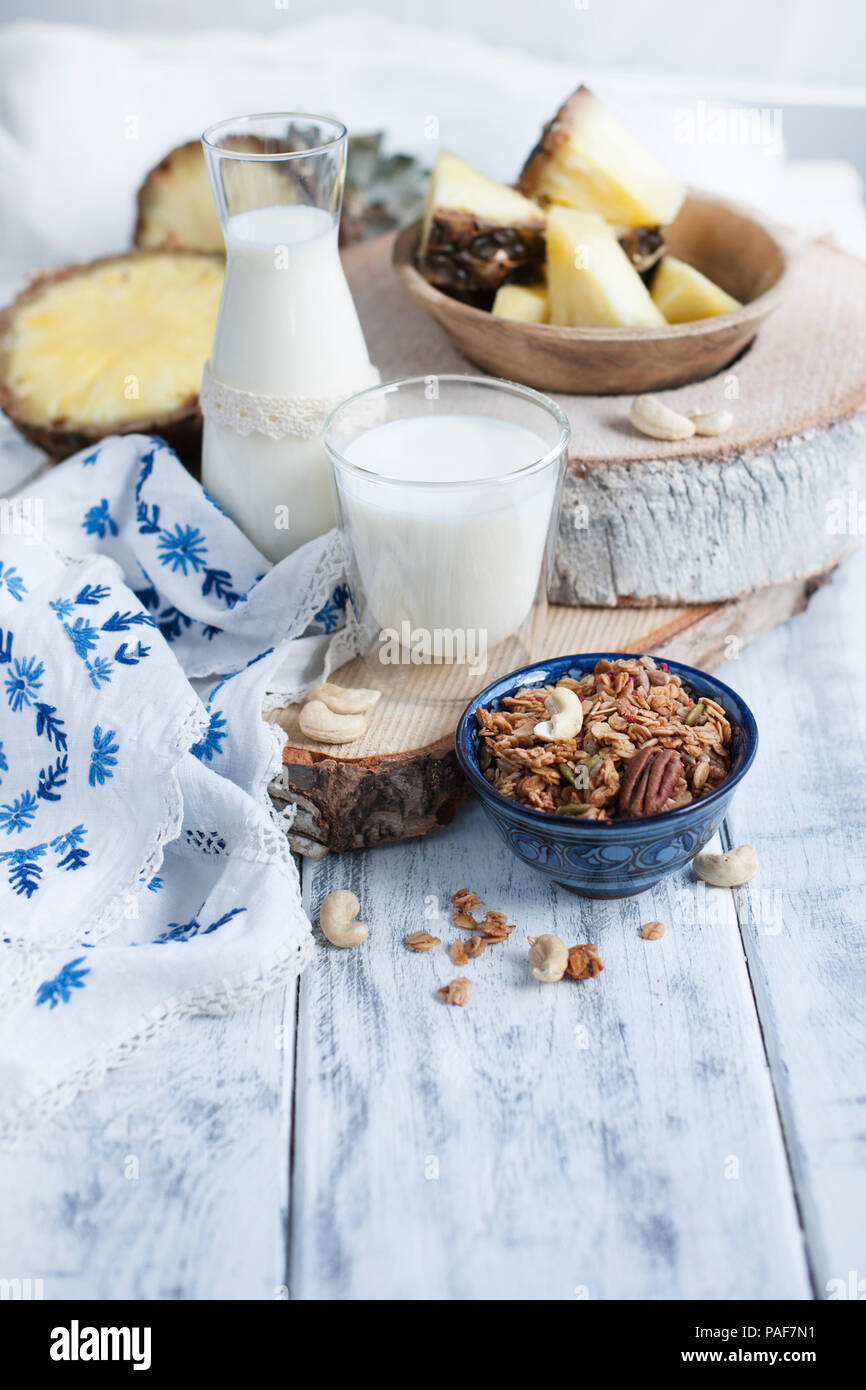 Milk in a bottle, pineapple and ganola fruit for breakfast. Delicious ...