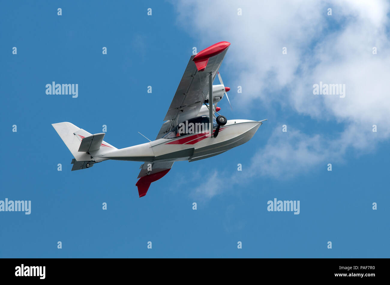 white twin-engine light hydroplane make flight, aloft in blue sky Stock ...