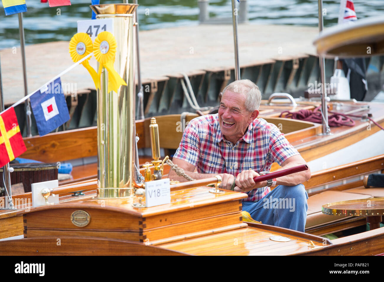 Nigel Cooper works on his steam boat 'Halcyon' as people enjoy the warm ...