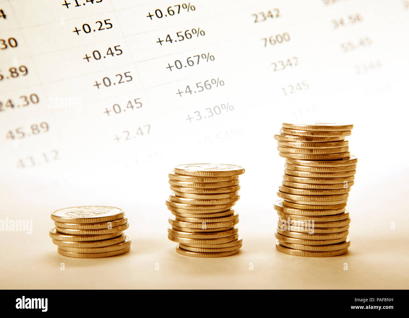 three stacks of golden coins with accounting digits close up Stock ...