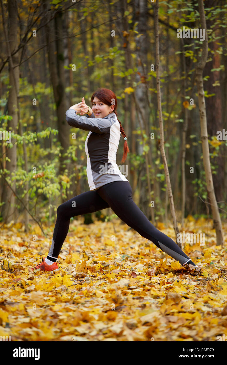 Picture of sports fitness brunette doing stretching exercises at fresh ...