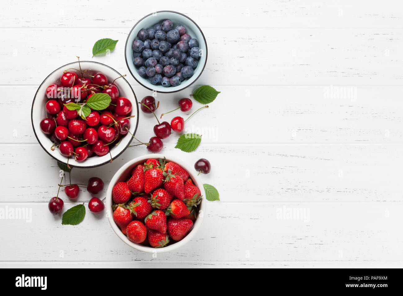 Fresh summer berries. Cherry, blueberry and strawberry. Top view with ...