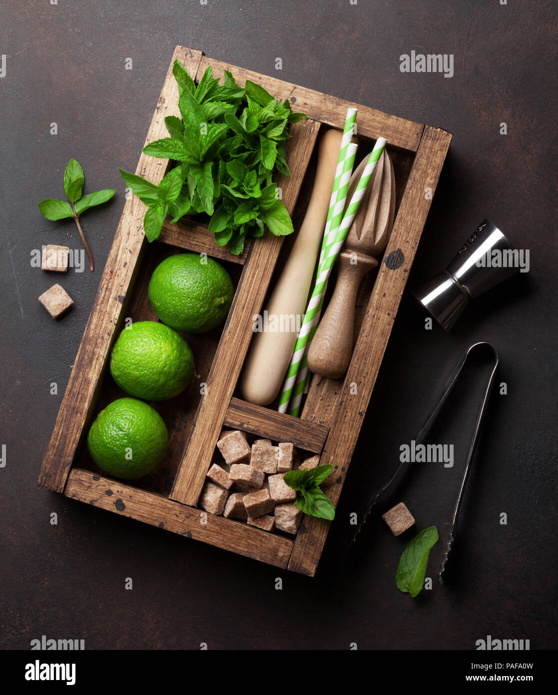 Mojito cocktail ingredients and bar accessories box on stone table. Top ...