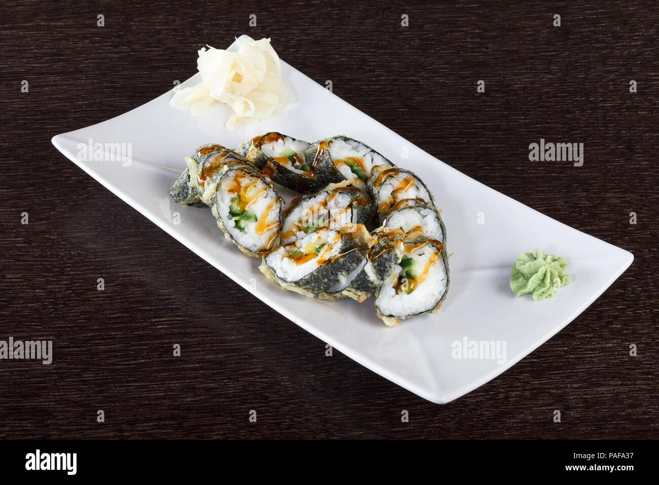 Sushi rolls with avocado on wooden table. Side view Stock Photo - Alamy