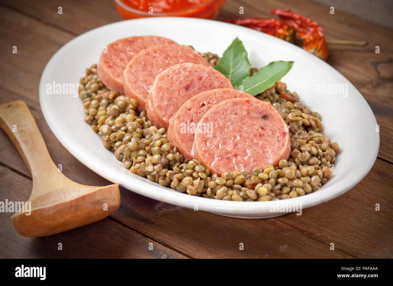 Italian cotechino with lentils on Christmas table Stock Photo - Alamy