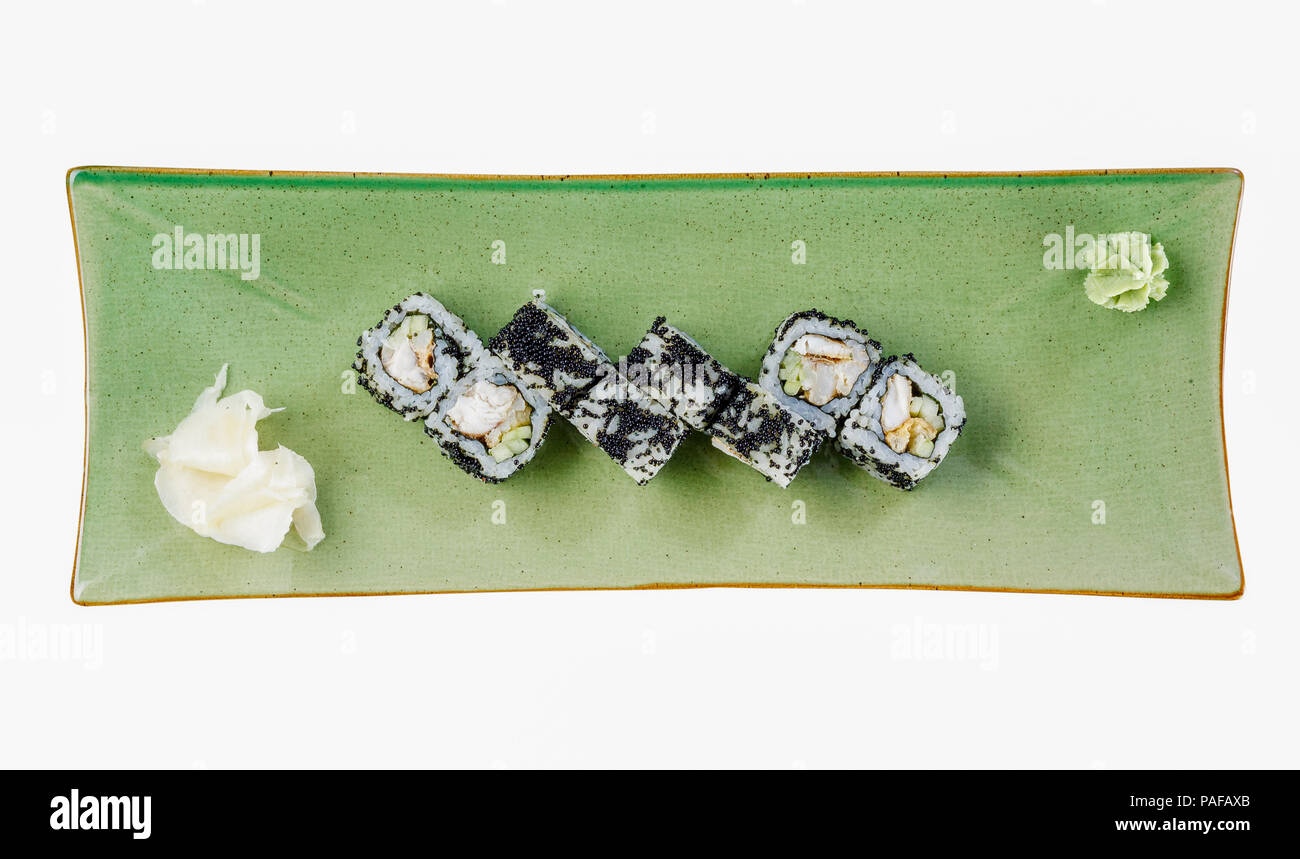 Sushi rolls with tuna and flying fish roe on a plate with wasabi and ...