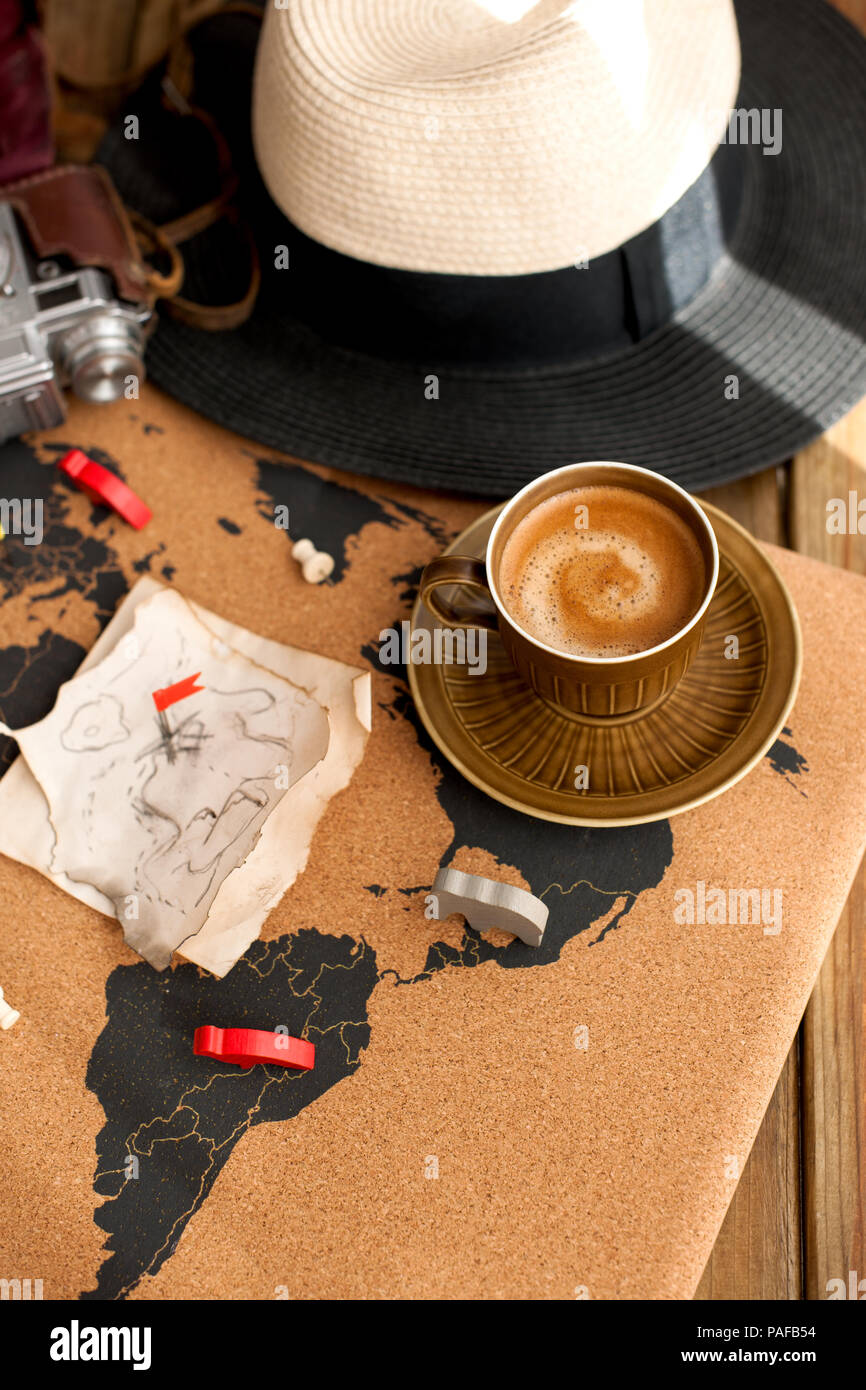 An old map, a camera, a hat, a fragrant morning coffee. Retro style ...