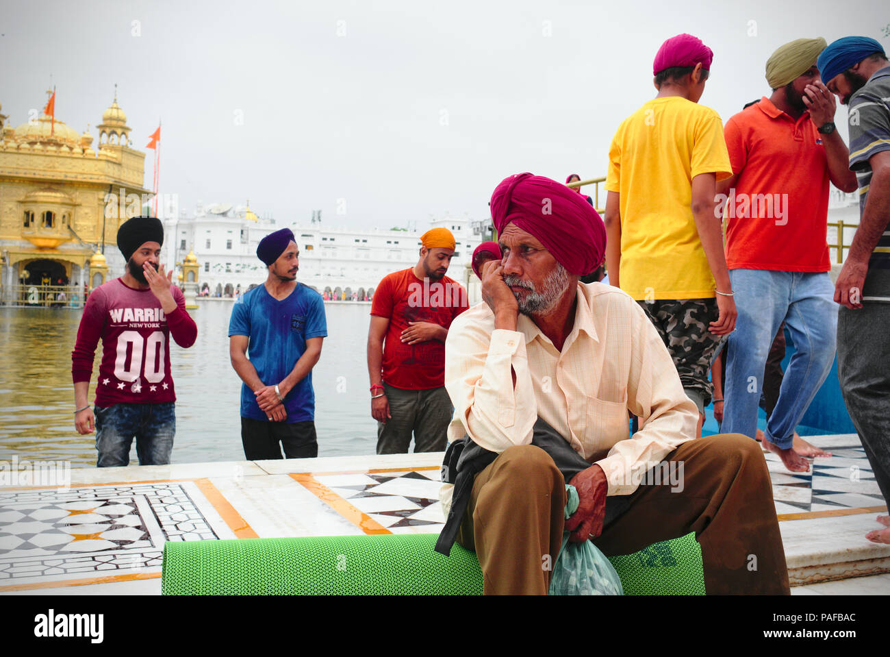 People at Harmandir Sahib, the Golden Temple, and by its sacred pool ...