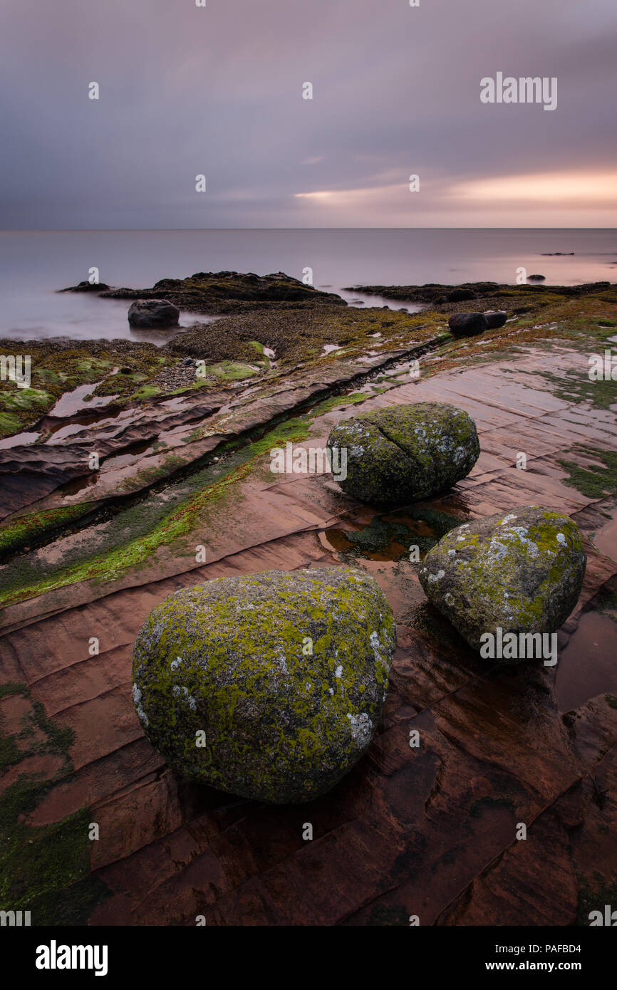 Sunrise - erratic boulders, Corrie coast - Isle of Arran Stock Photo ...