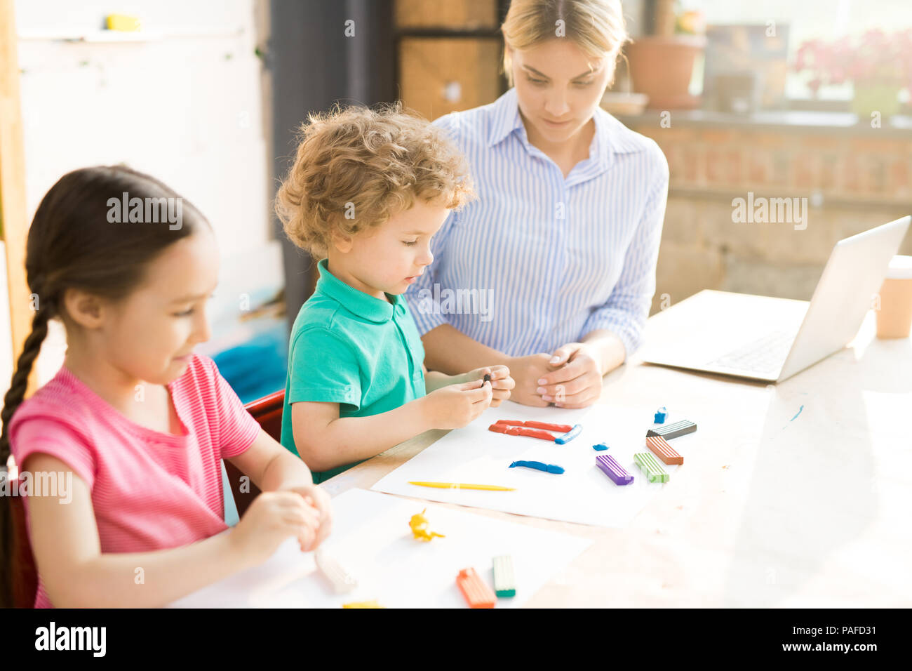 Children sculpting from play clay Stock Photo - Alamy