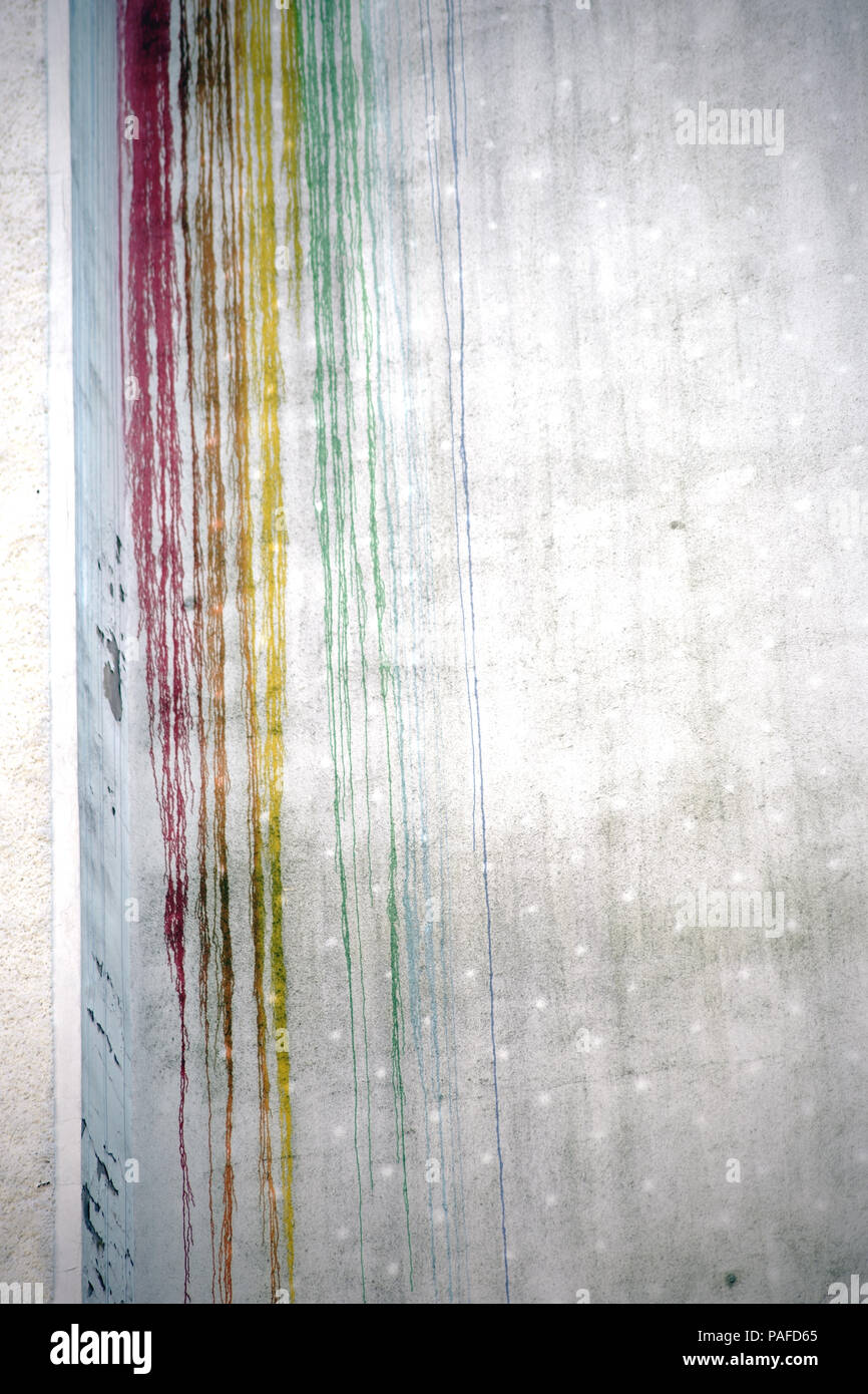 The colorful paint strokes and splashes of color on a concrete facade ...