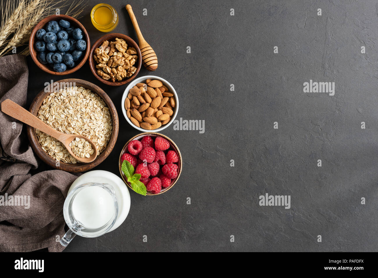 Nutrition Healthy Eating Ingredients on Black Concrete Background. Oats ...