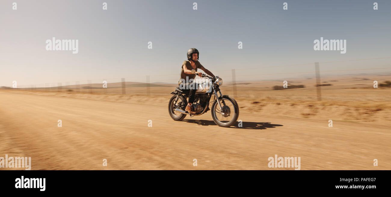 Young man riding motorbike off-road. Man riding on a motorcycle on ...