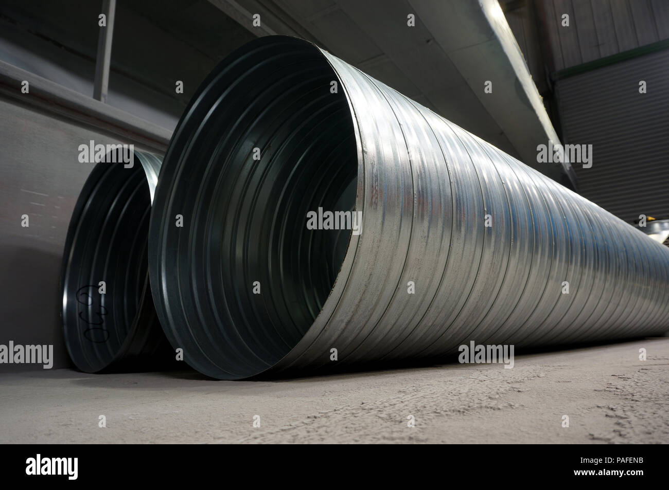 Galvanised steel ducting tubing for air extraction on the floor of a ...