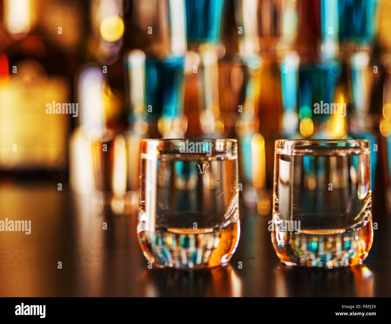 Traditional pure vodka in glasses on a black background, chilled drink ...