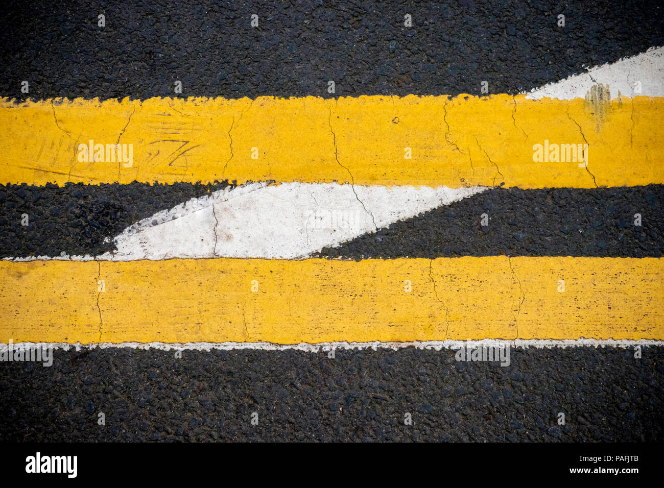 Two yellow lines and one white line on a road Stock Photo - Alamy