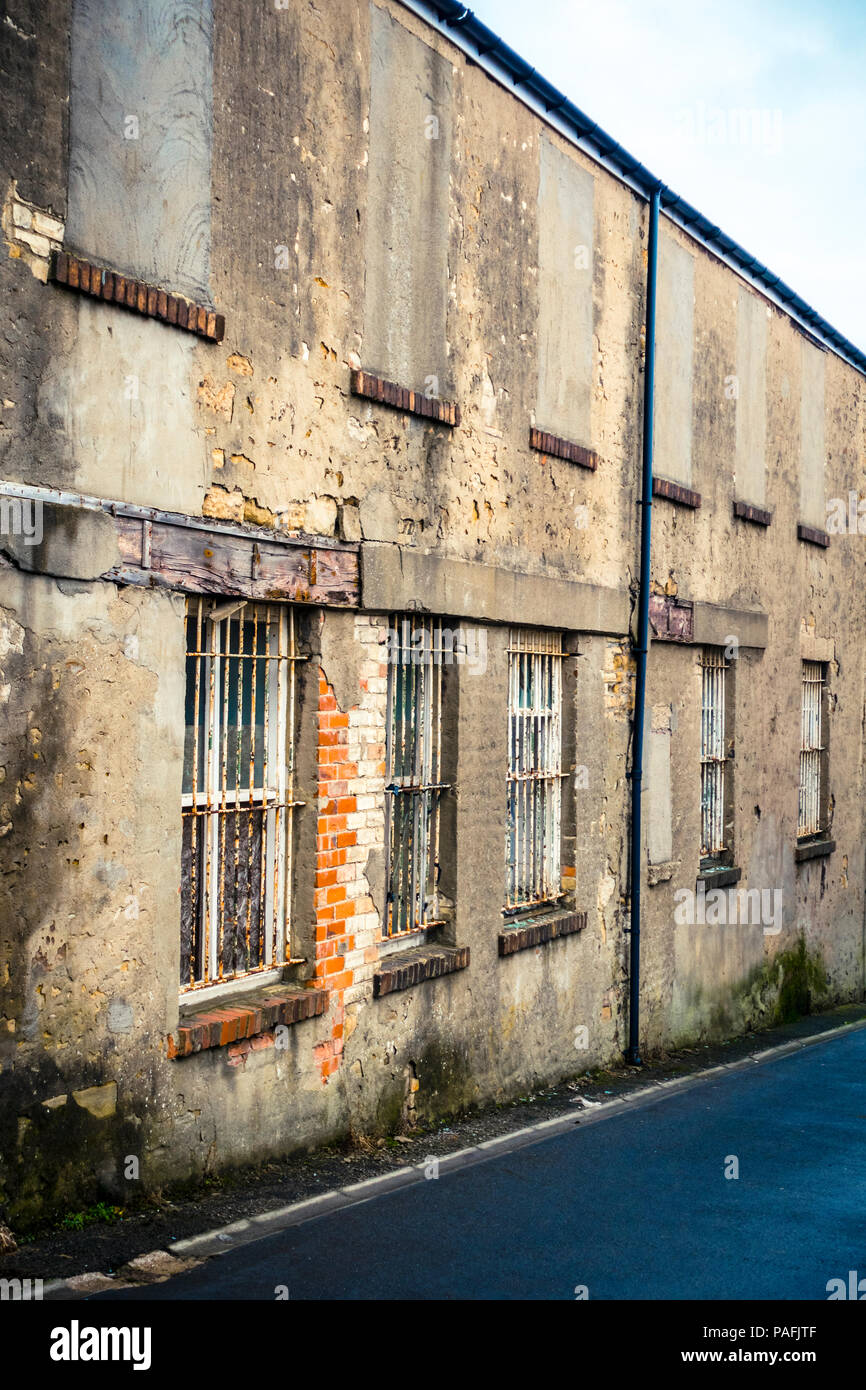 Old building with barred windows and worn and weathered walls Stock ...