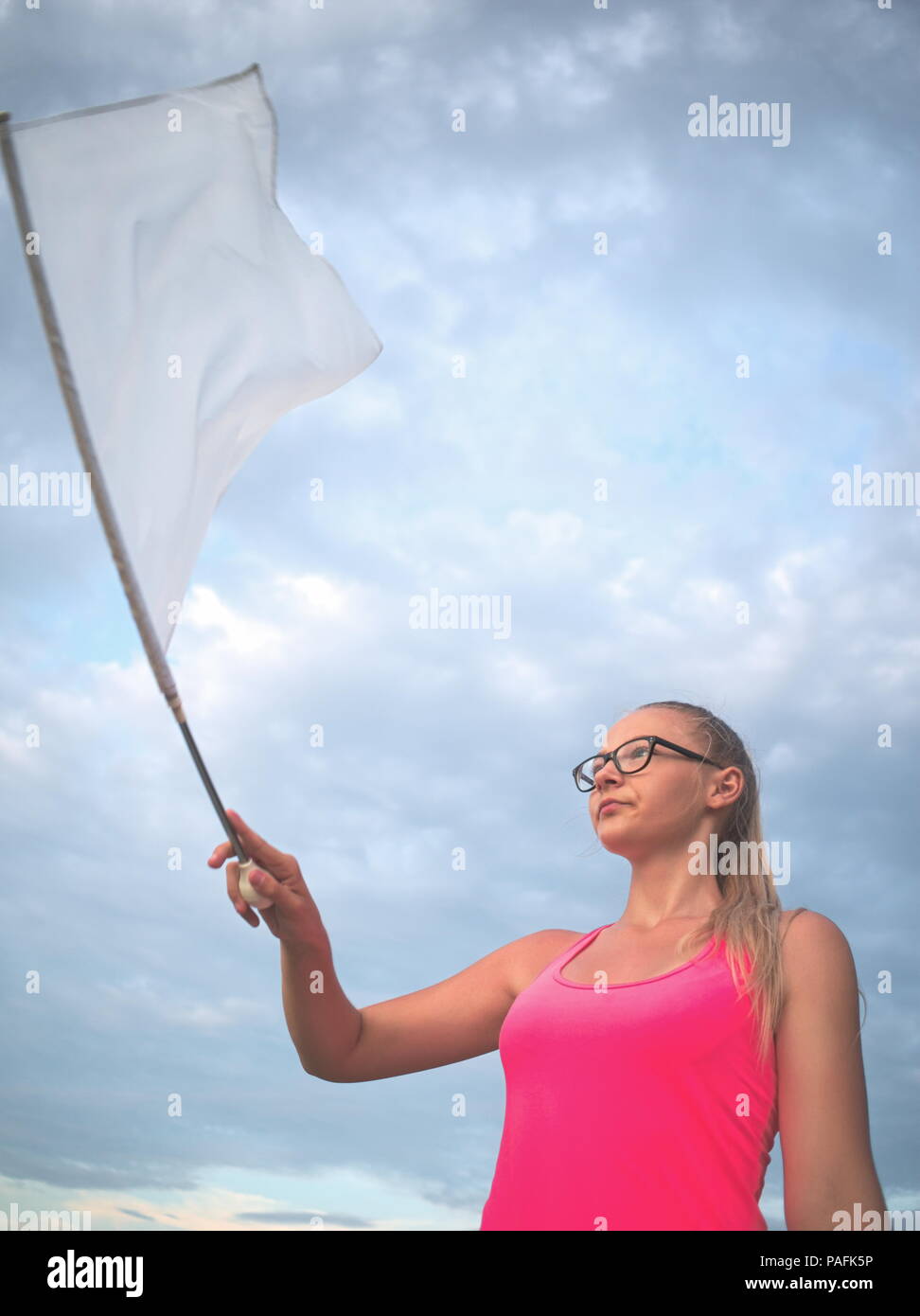 Bespectacled Blonde Teen Majorette Girl with White Flag Outdoors Stock ...