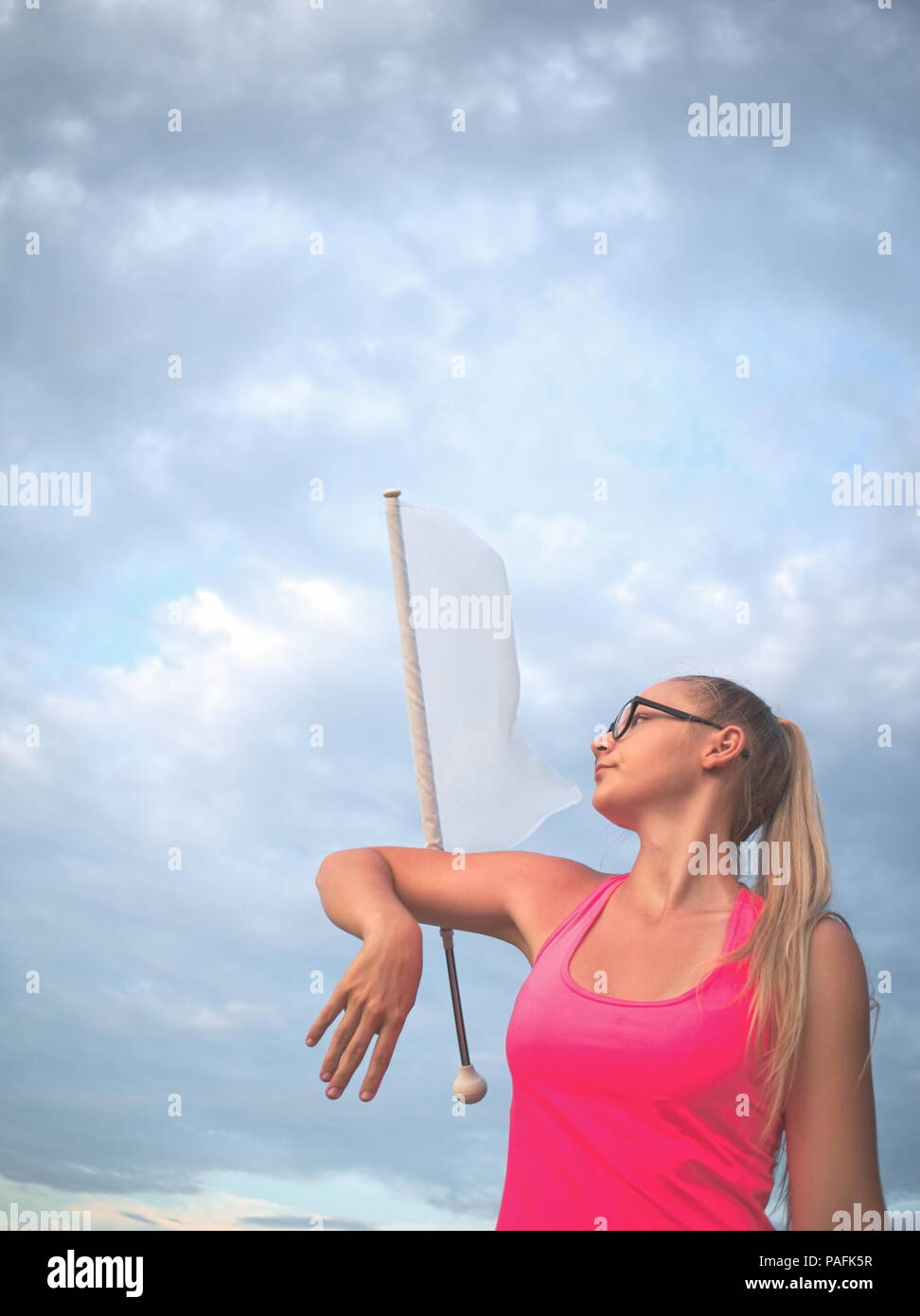 Bespectacled Blonde Teen Majorette Girl with White Flag Outdoors Stock ...