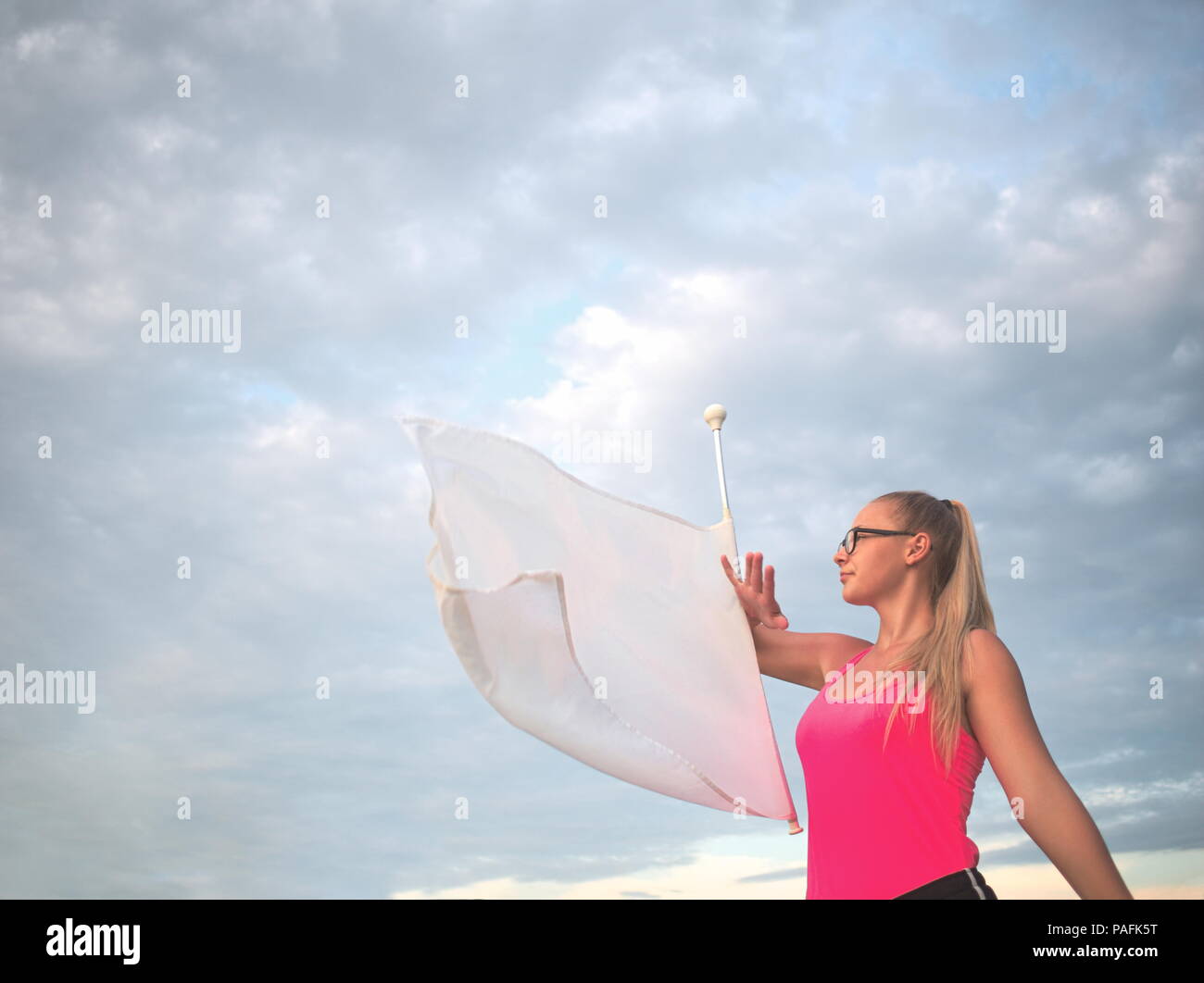 Bespectacled Blonde Teen Majorette Girl with White Flag Outdoors Stock ...