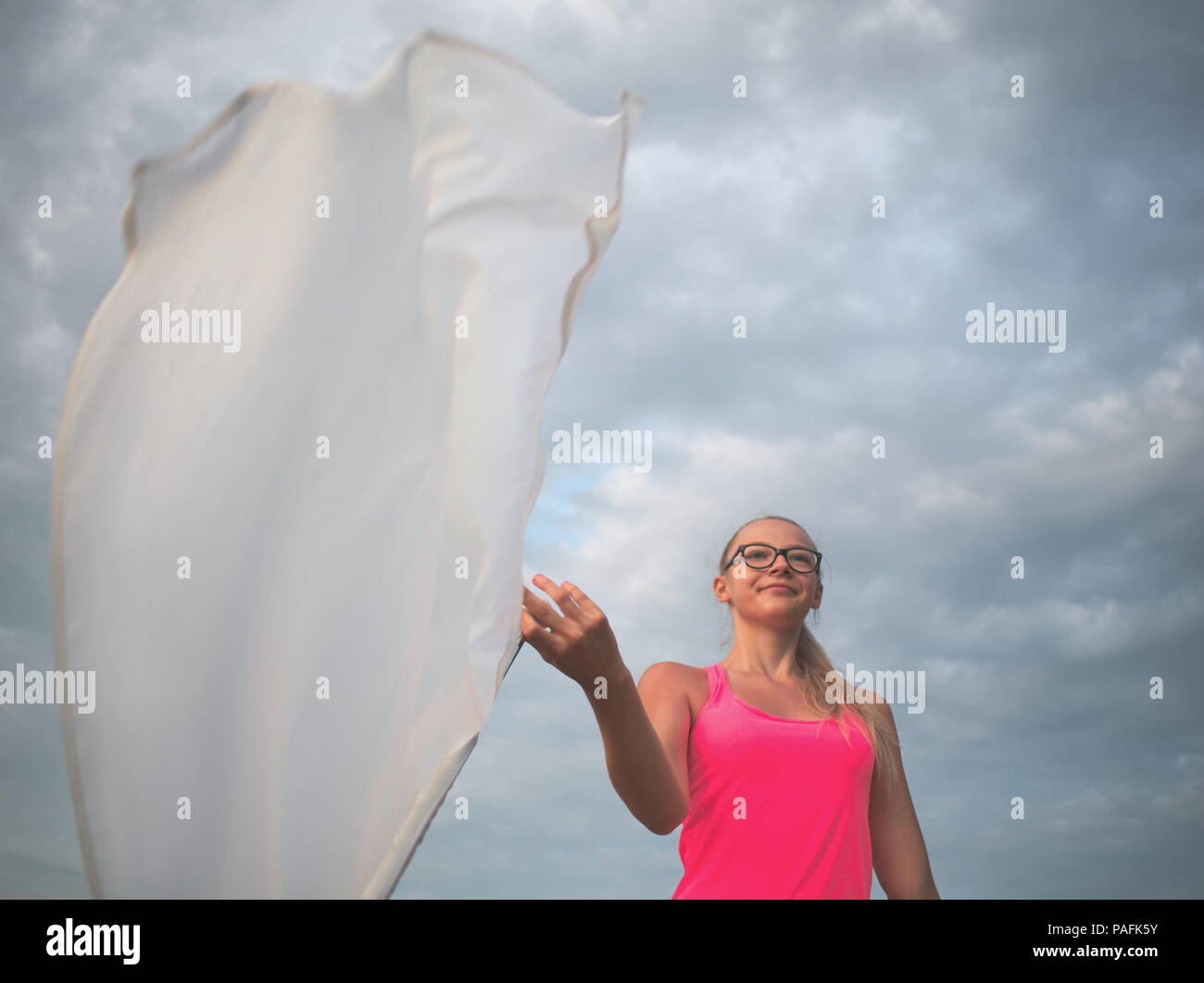 Bespectacled Blonde Teen Majorette Girl with White Flag Outdoors Stock ...