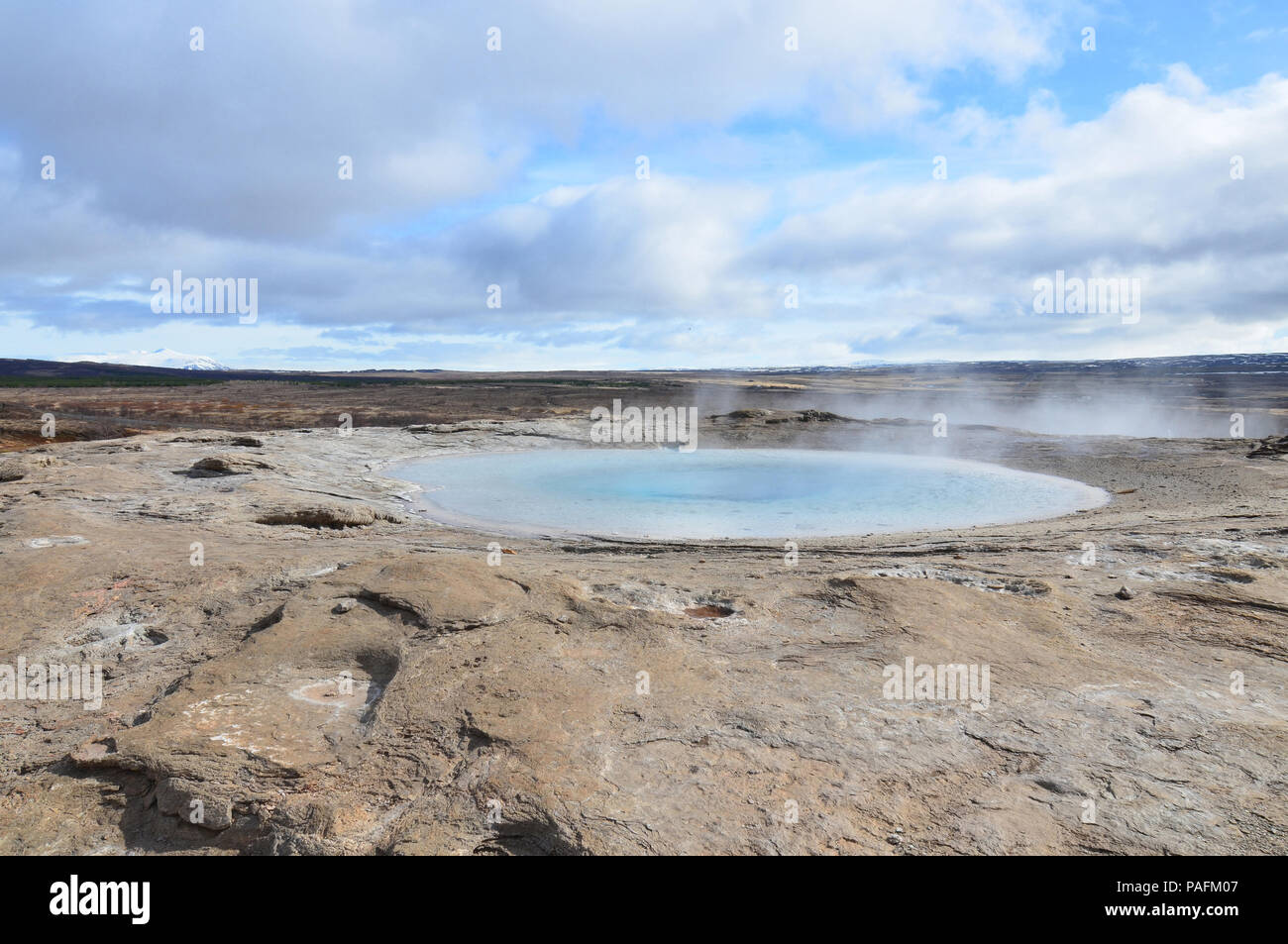 Cloudy but blue sky with a beautiful blue hot spring geyser Stock Photo ...