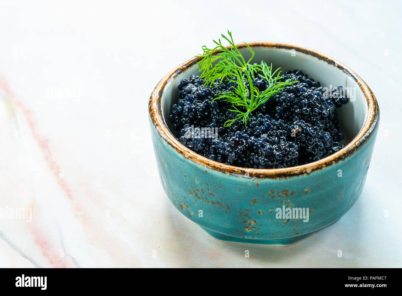 Black lumpfish caviar in a small pot Stock Photo - Alamy
