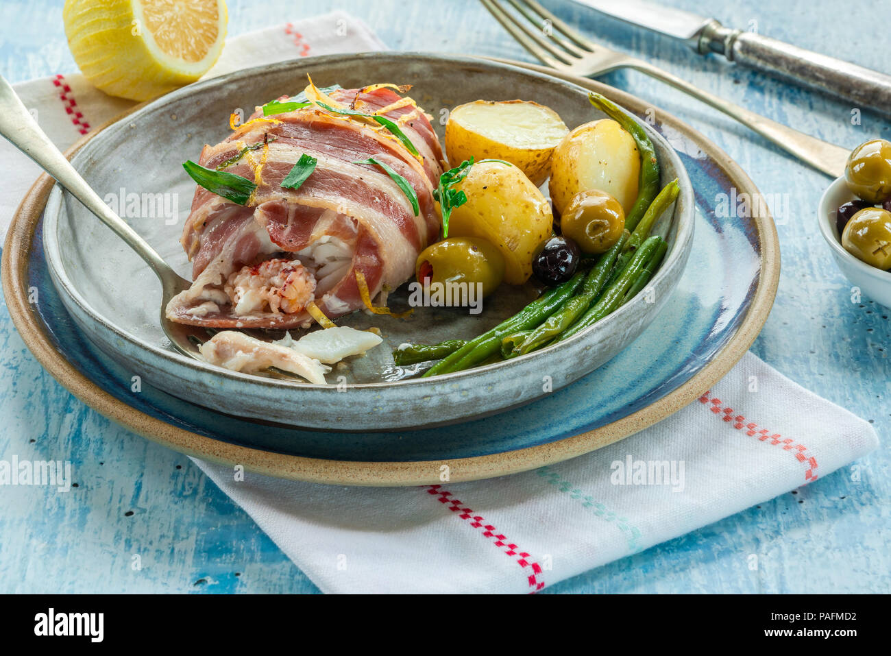 Bacon-wrapped haddock stuffed with crayfish tails, with lemony new ...