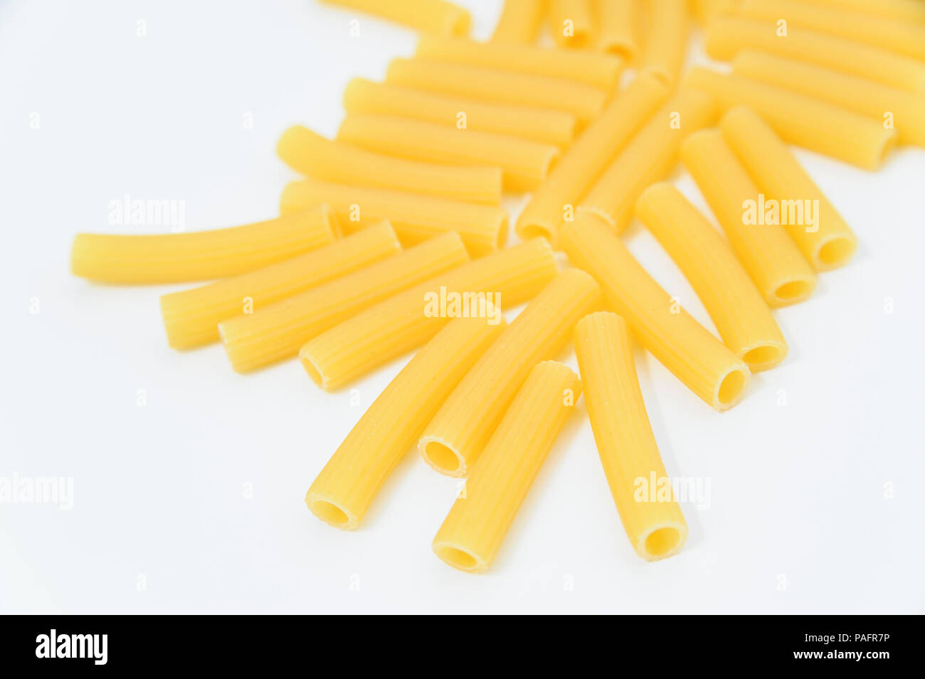 Pasta tubular are placed on a white background Stock Photo - Alamy