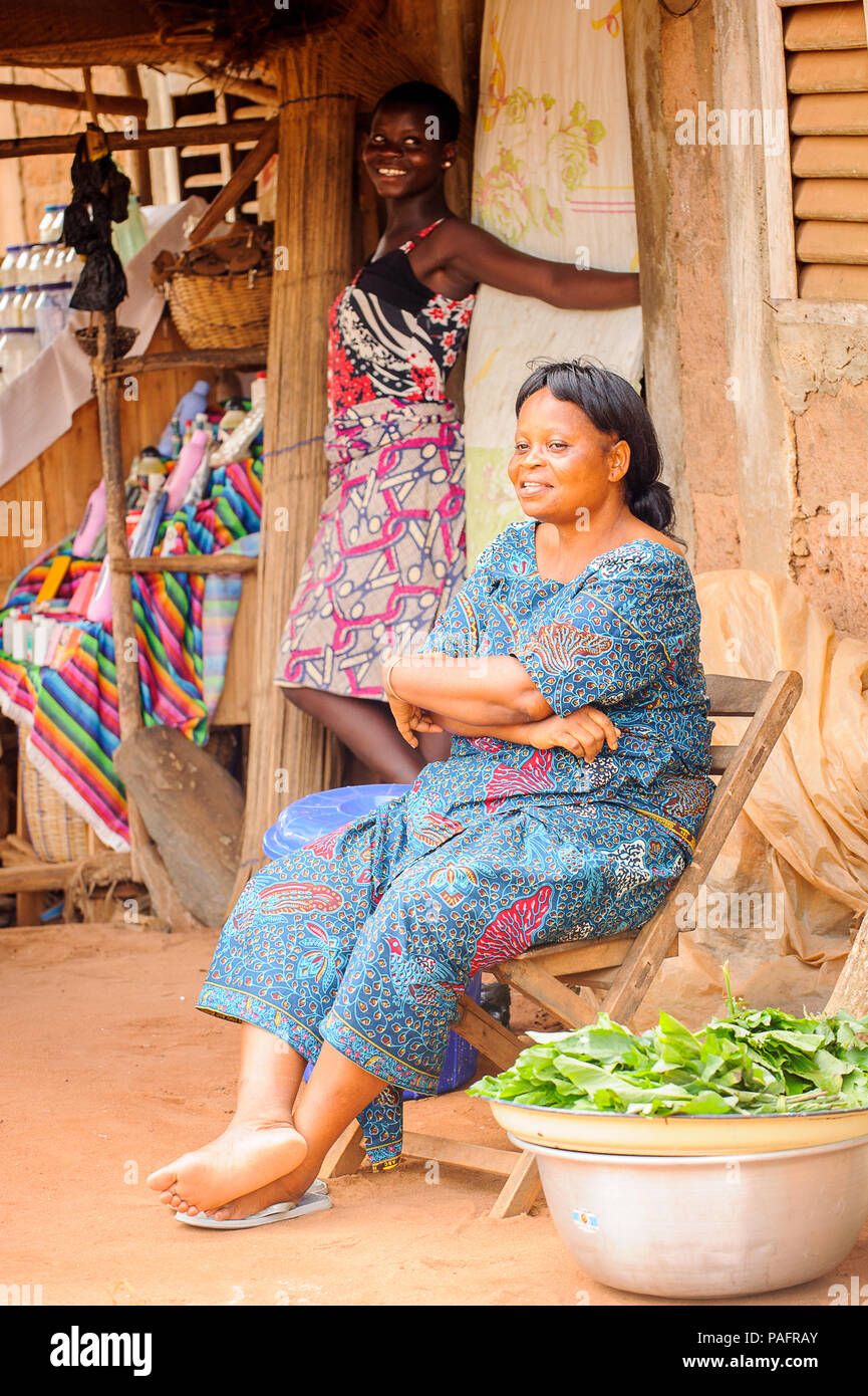 PORTO-NOVO, BENIN - MAR 9, 2012: Unidentified Beninese woman sits near ...