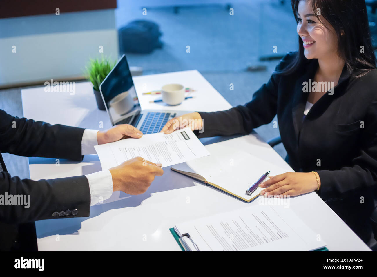 Businessmen and Businesswomen discussing documents for job interview ...