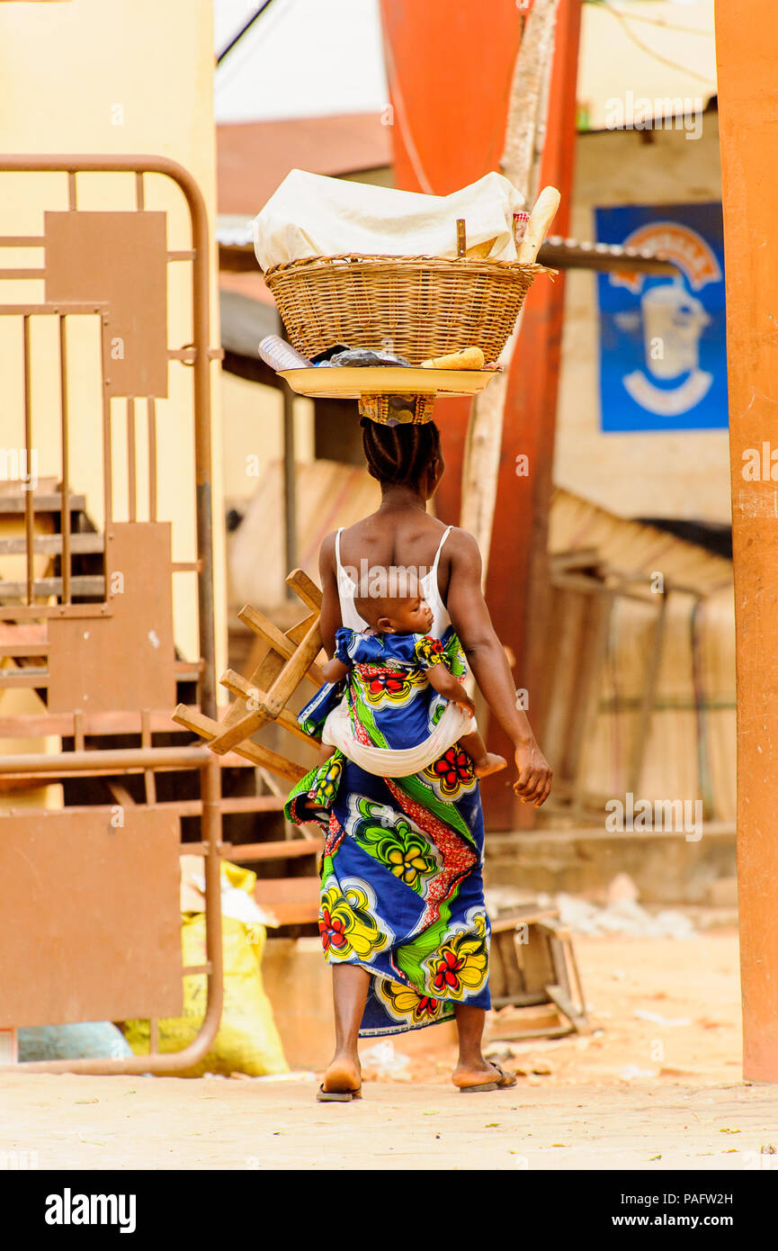 PORTO-NOVO, BENIN - MAR 10, 2012: Unidentified Beninese woman carries ...