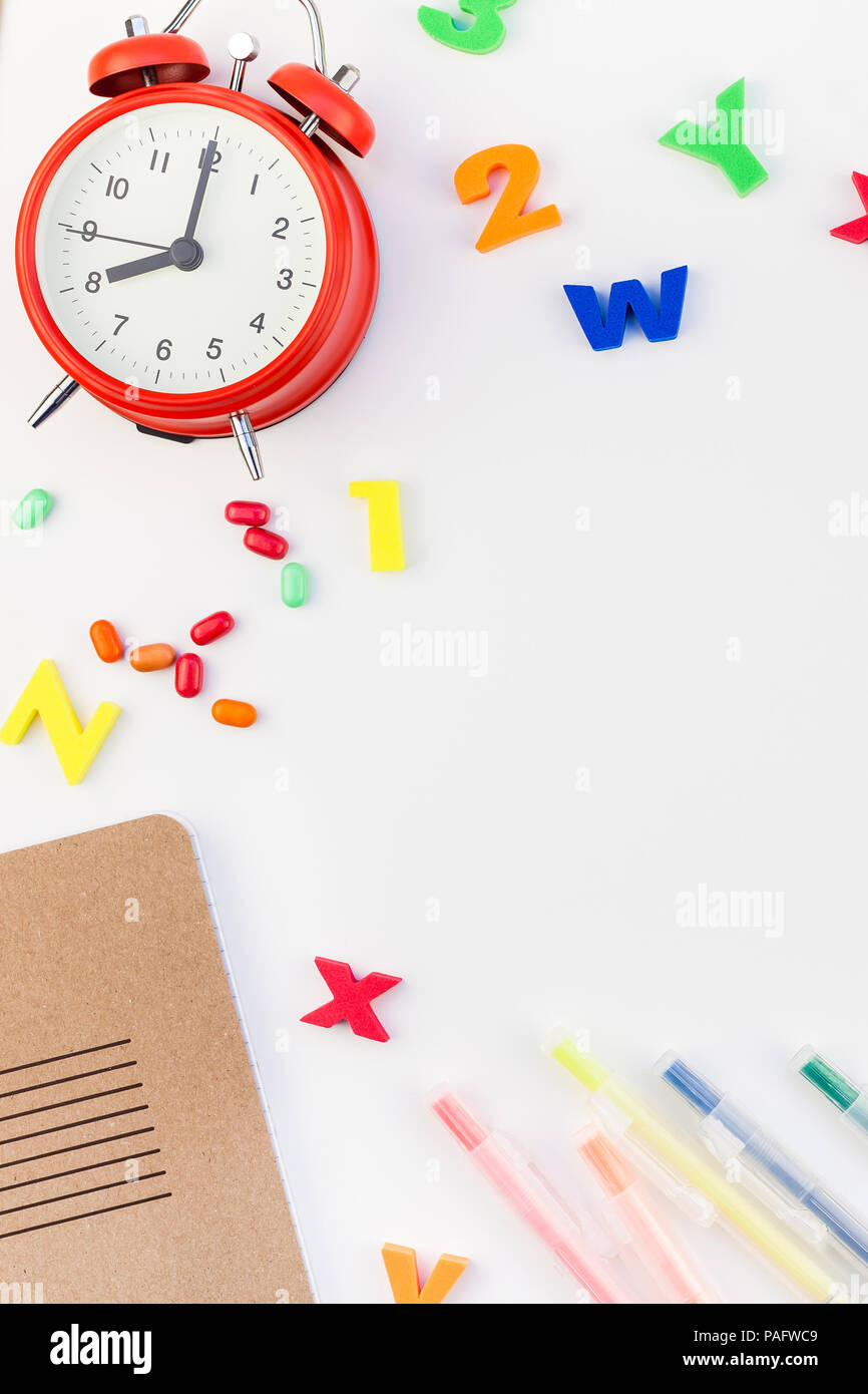 Creative flat lay back to school concept with alarm clock, color school ...