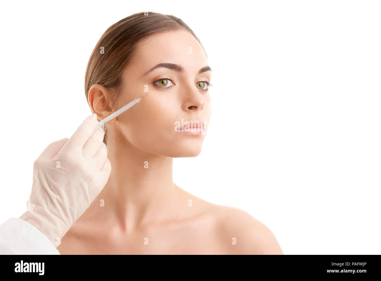 Portrait of an attractive young woman receiving botox treatment ...