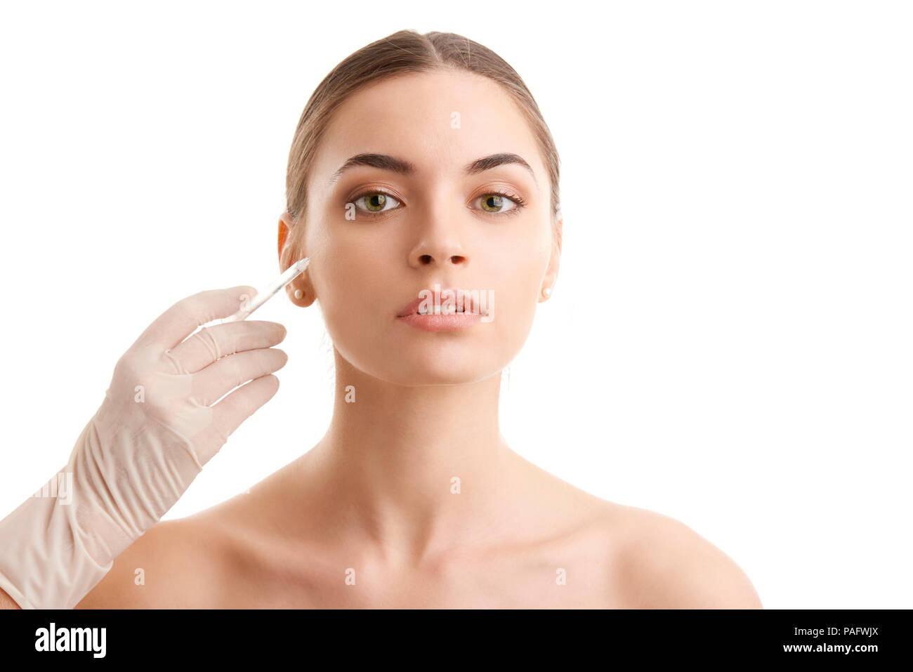 Portrait of an attractive young woman receiving botox treatment ...