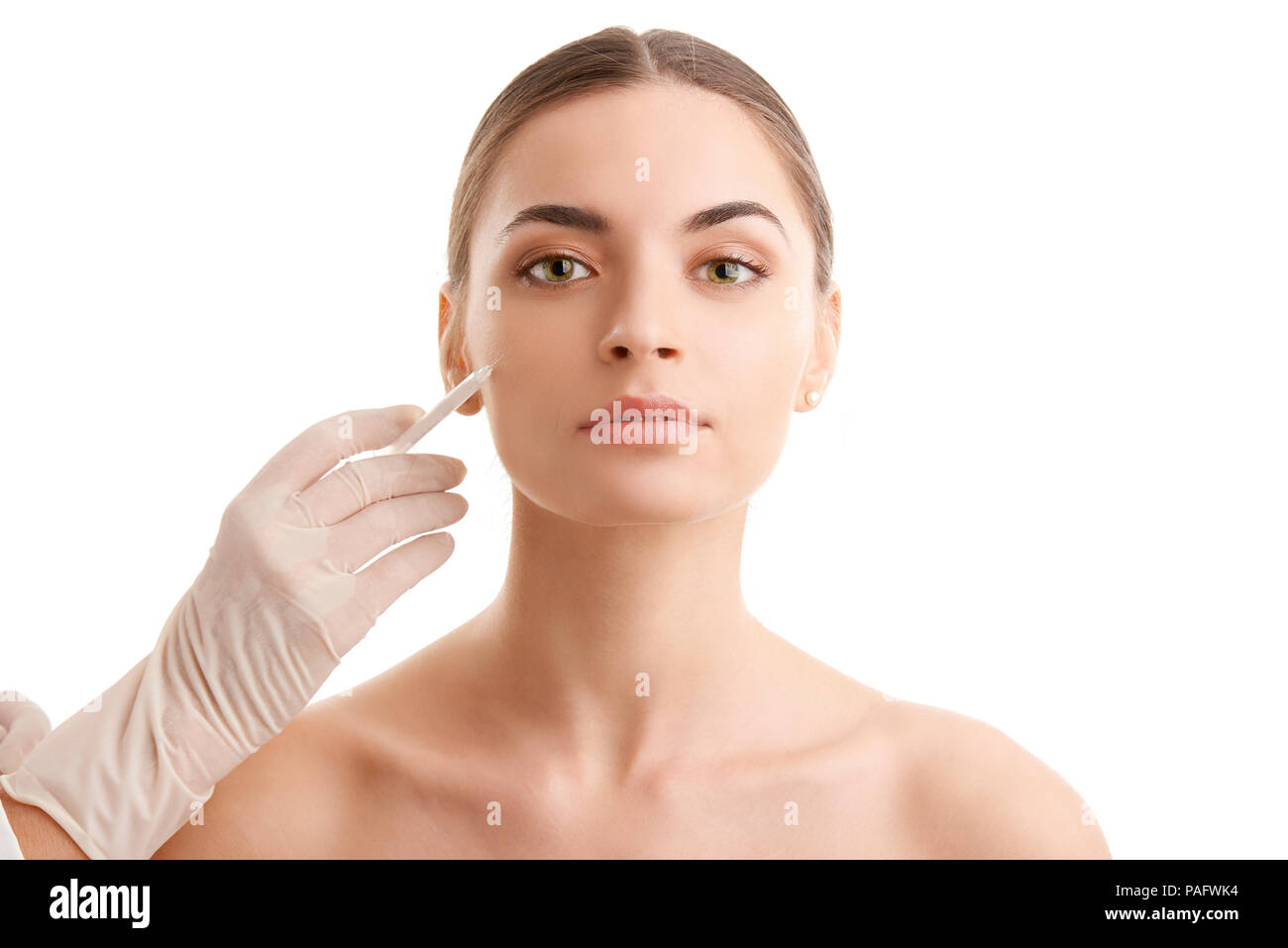 Portrait of an attractive young woman receiving botox treatment ...