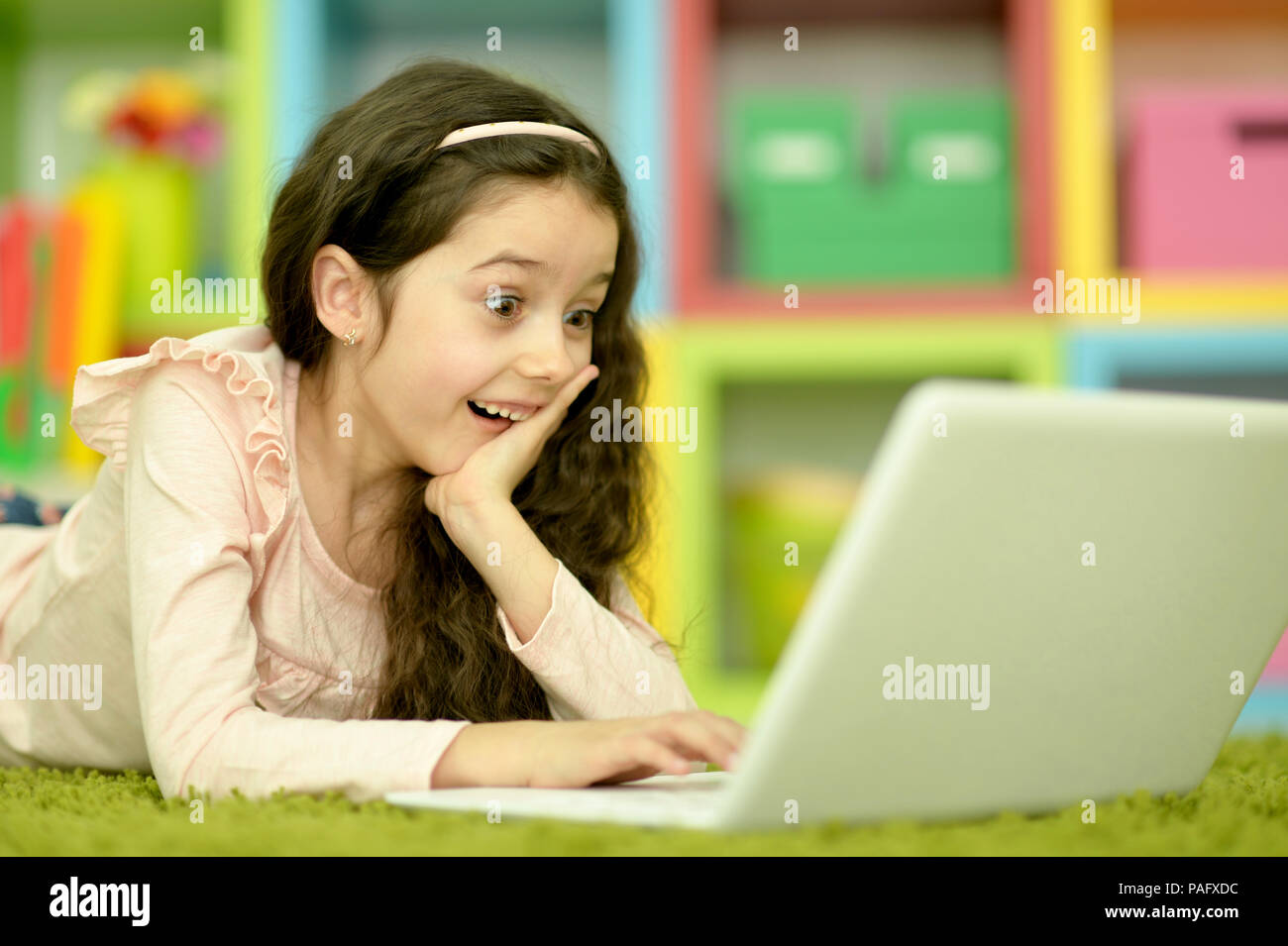 Emotional cute girl using laptop Stock Photo - Alamy