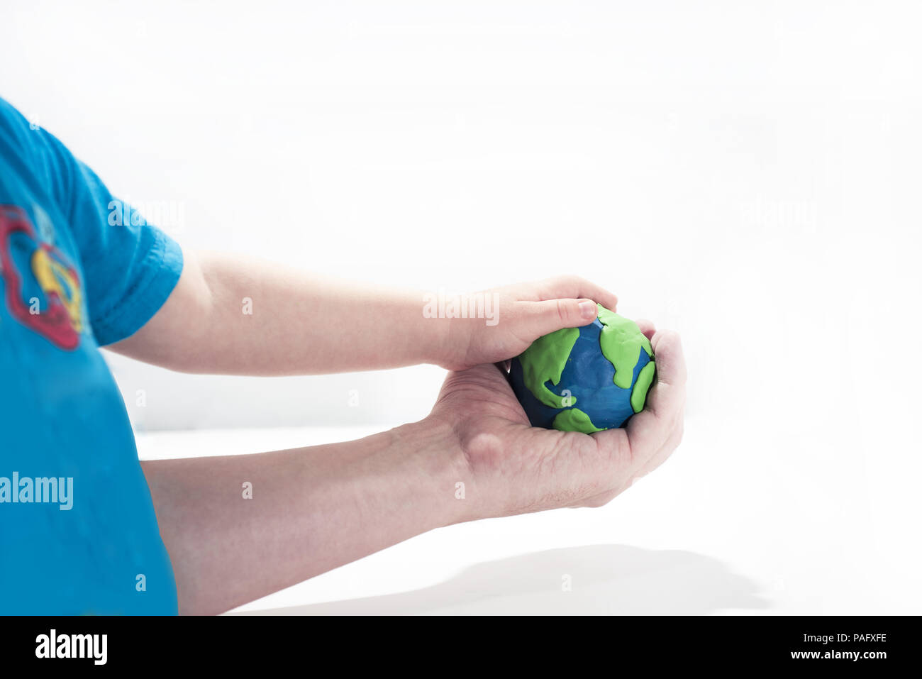 Small Earth model with human hands. Abstract composition of peace Stock ...