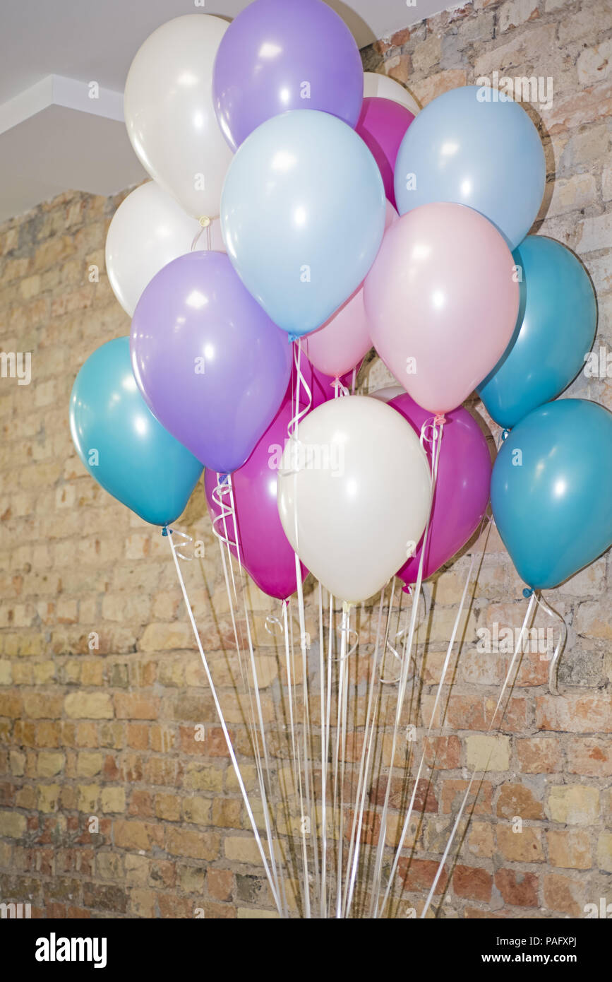 A lot of balloons at front of bricks wall Stock Photo - Alamy