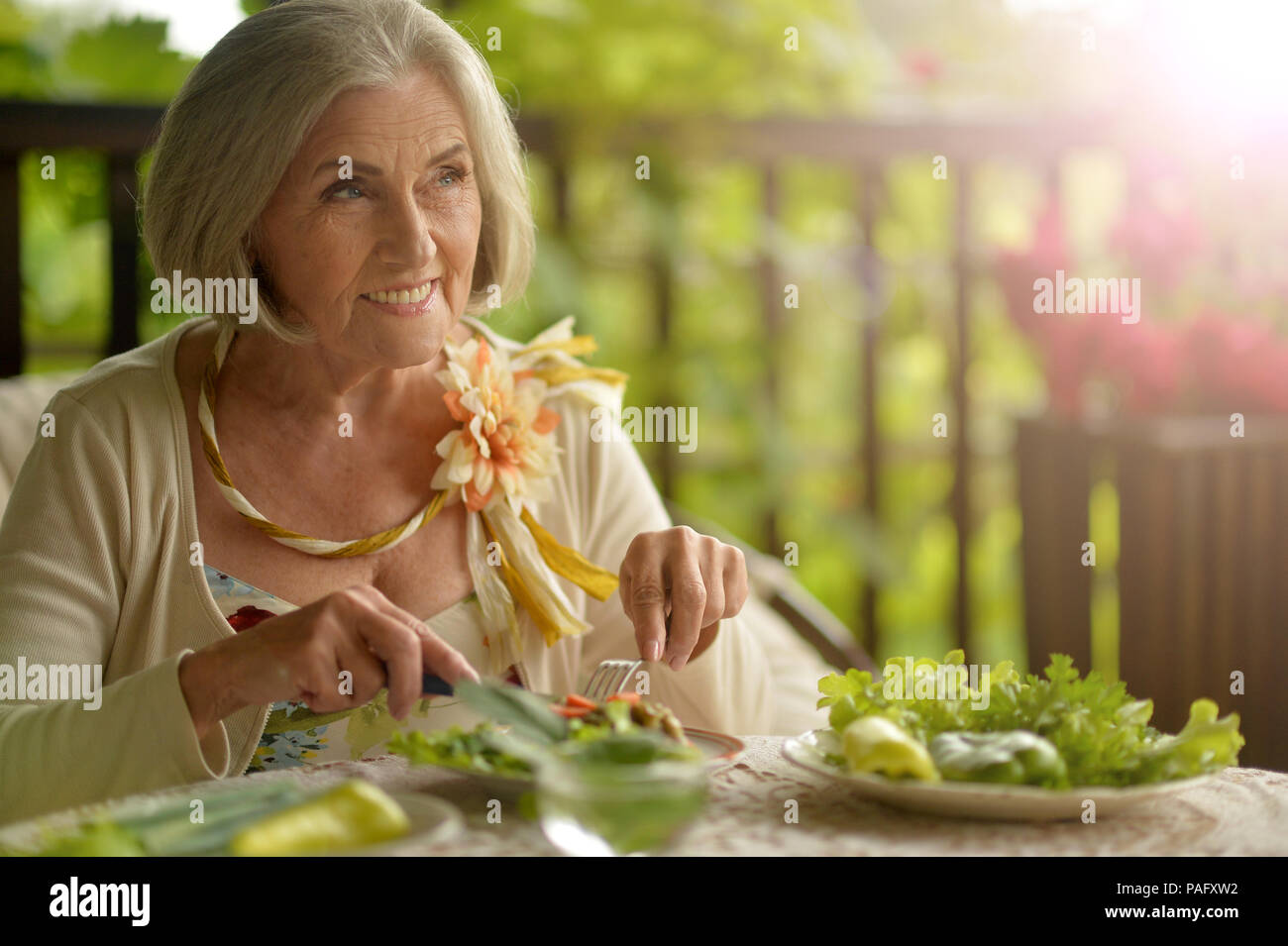 beautiful senior woman eating Stock Photo - Alamy